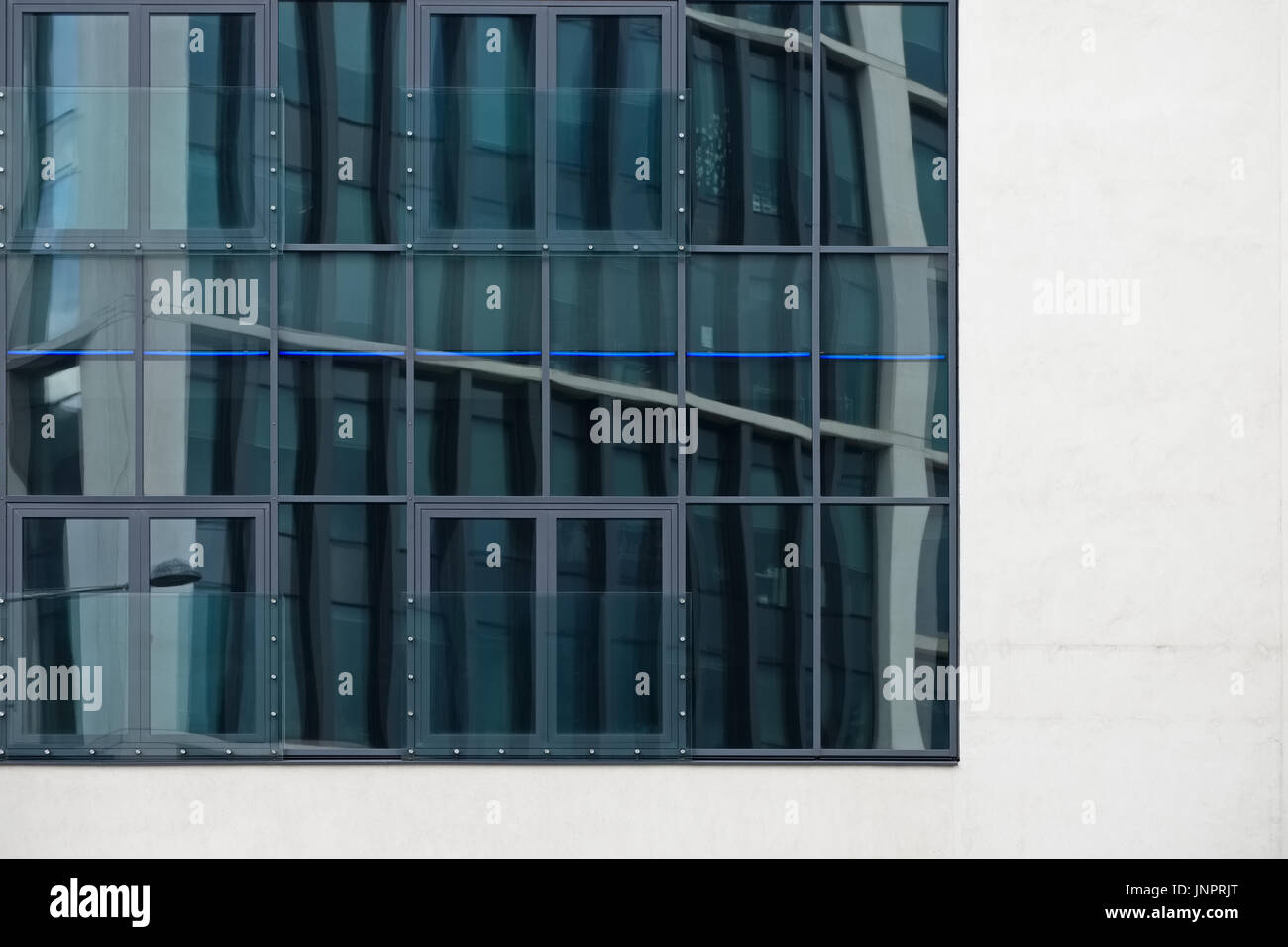 An abstract close-up of a section of a modern building reflected ...