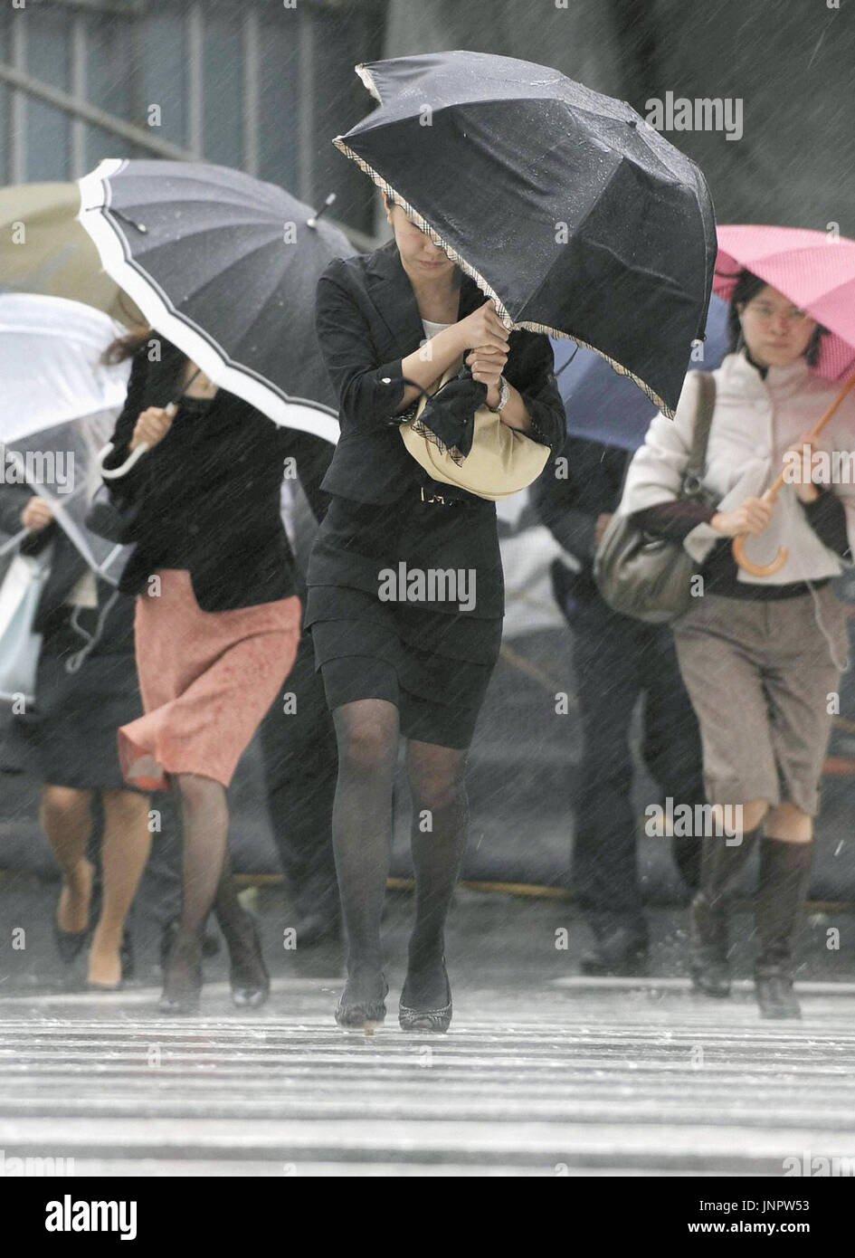 TOKYO, Japan - Braving strong winds and rain caused by Typhoon Melor ...