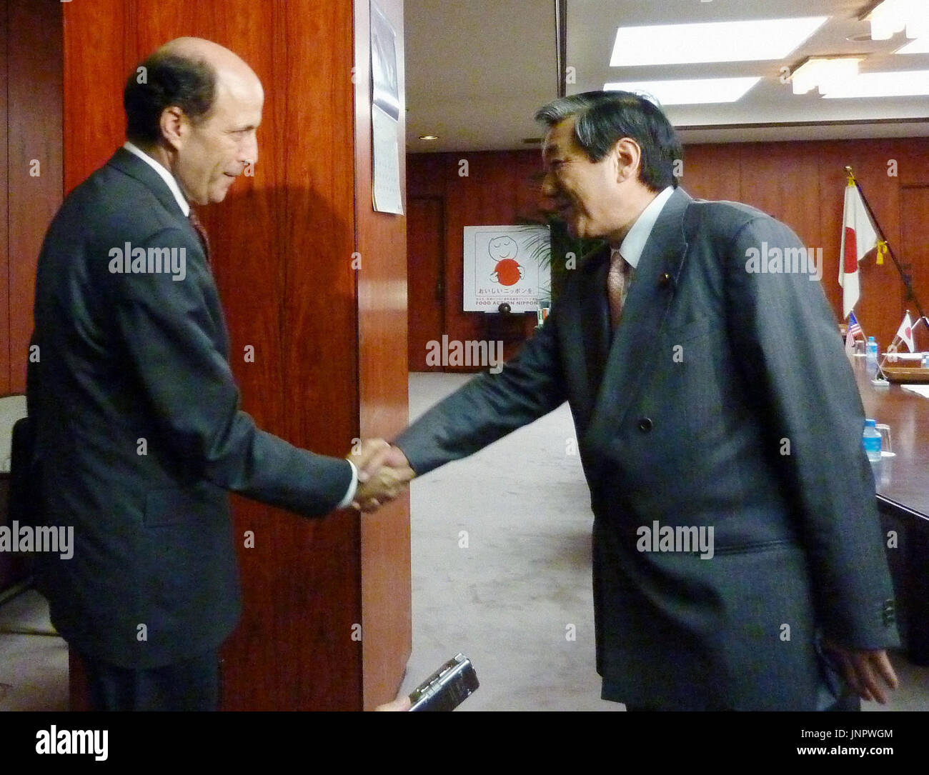 TOKYO, Japan - U.S. Ambassador to Japan John Roos (L) shakes hands with ...
