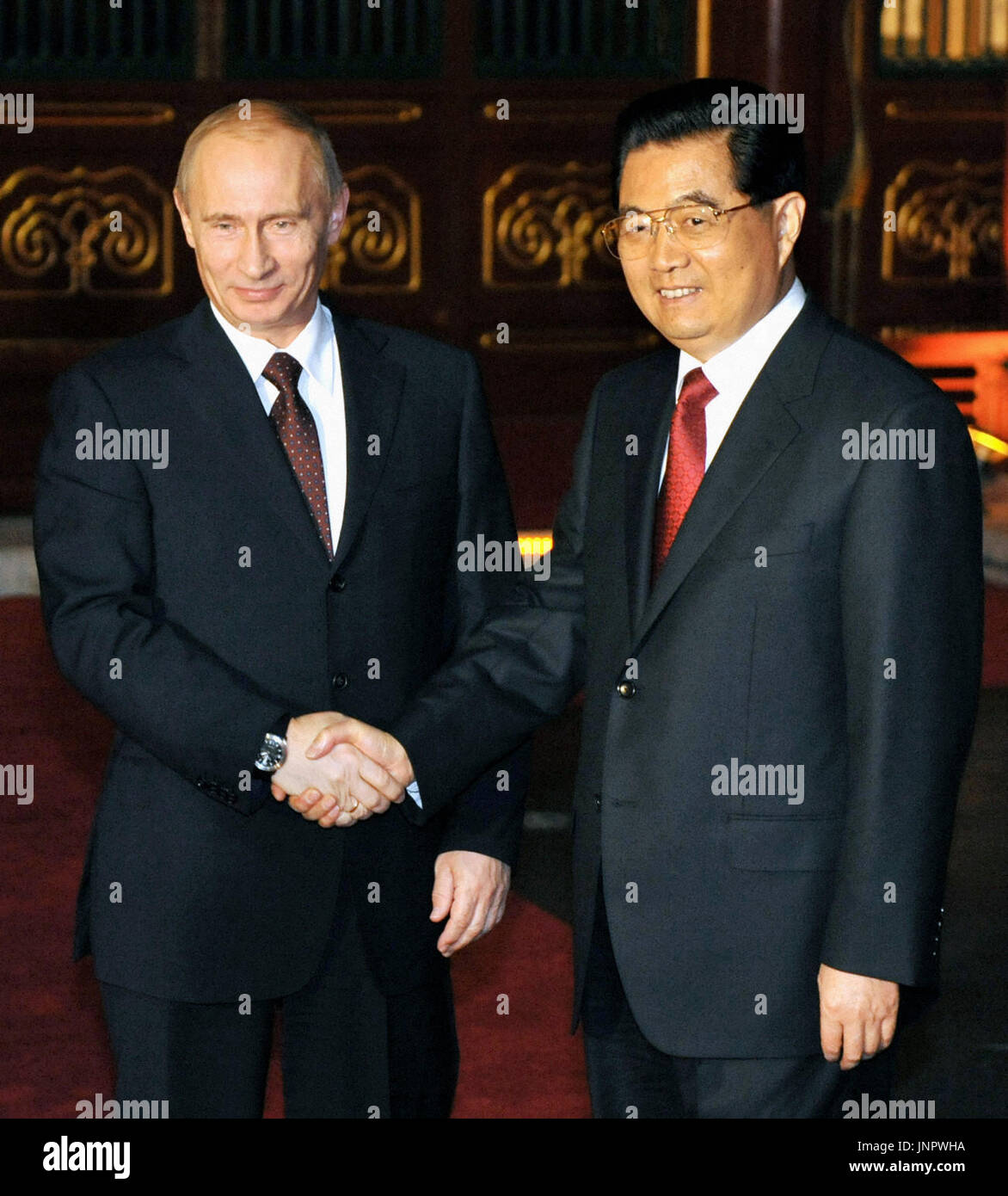 BEIJING, China - Russian Prime Minister Vladimir Putin (L) shakes hands ...
