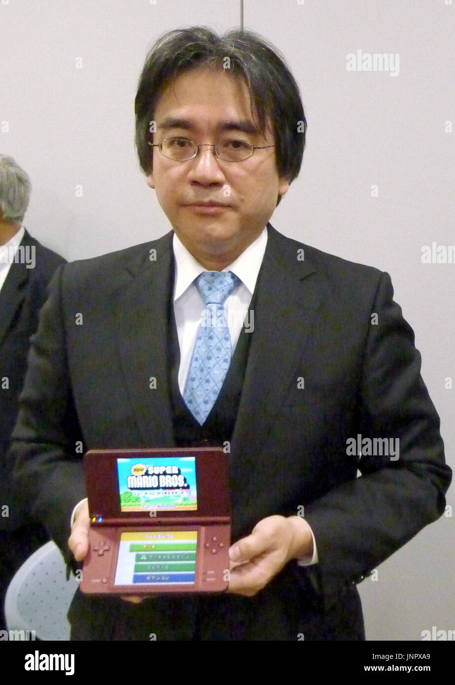 OSAKA, Japan - Nintendo Co. President Satoru Iwata holds a new version ...