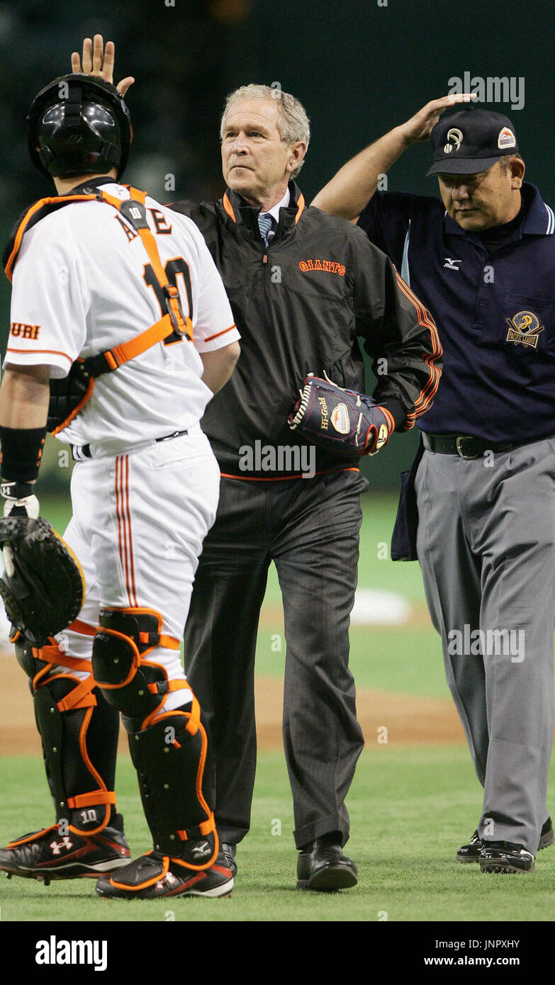 TOKYO, Japan - Former U.S. President George W. Bush pats Yomiuri Giants ...