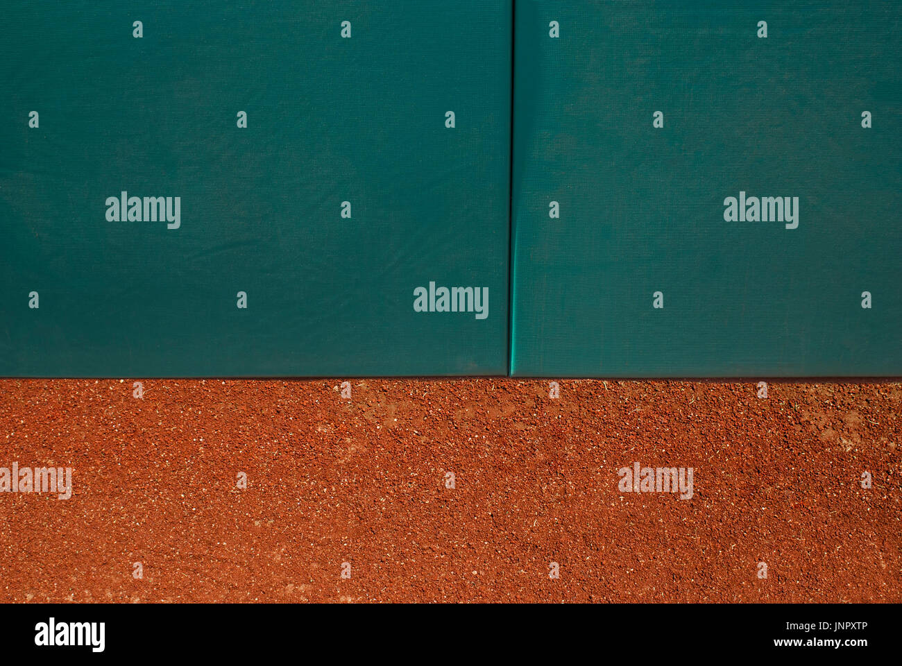Green baseball home run wall with track dirt Stock Photo - Alamy