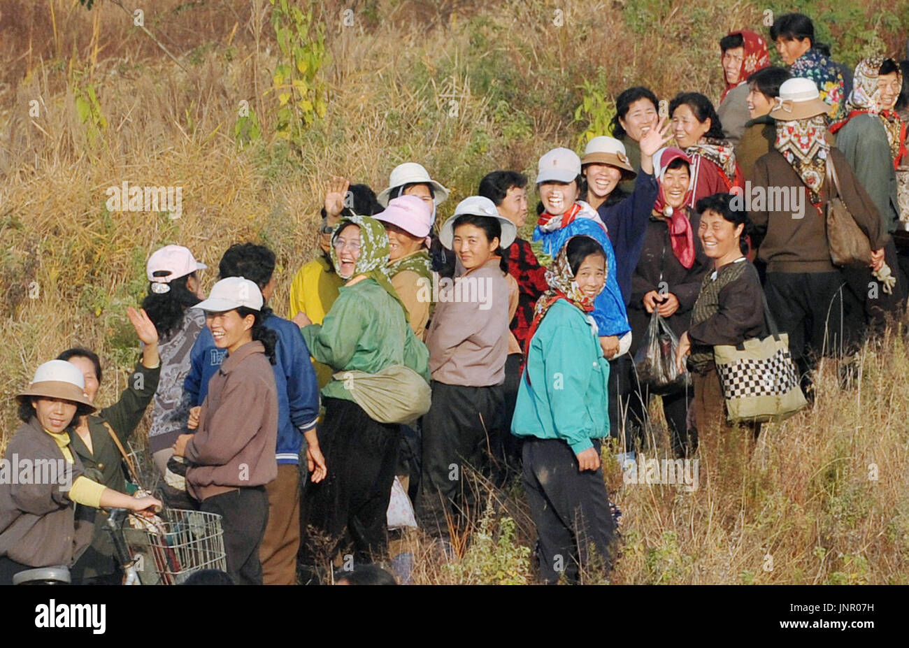PYONGYANG, North Korea - Women returning from agricultural work wave at ...