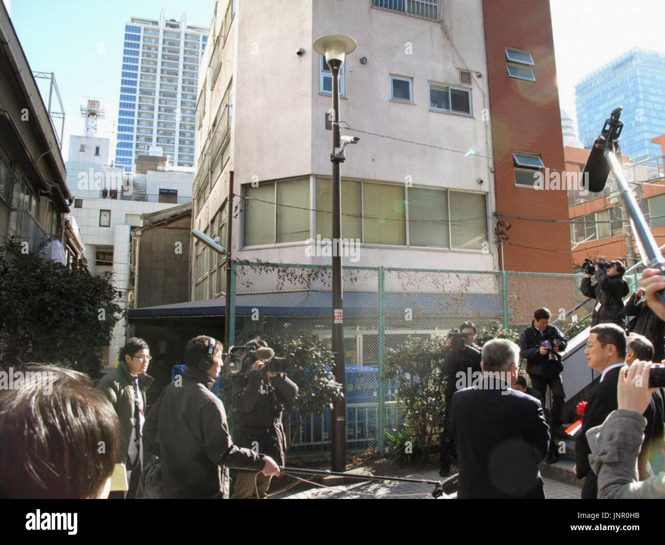 TOKYO, Japan - People gather around a security camera installed on a ...