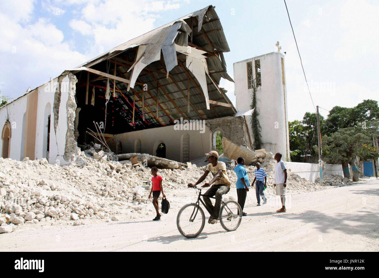 GRAND-GOAVE, Haiti - People walk past a collapsed church in Grand-Goave ...