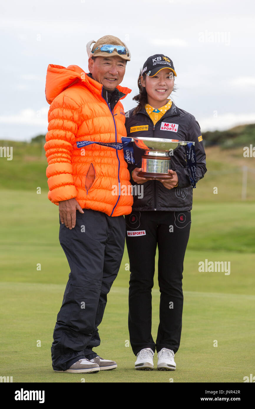 Korea's Mi Hyang Lee poses with the trophy and her father following her ...