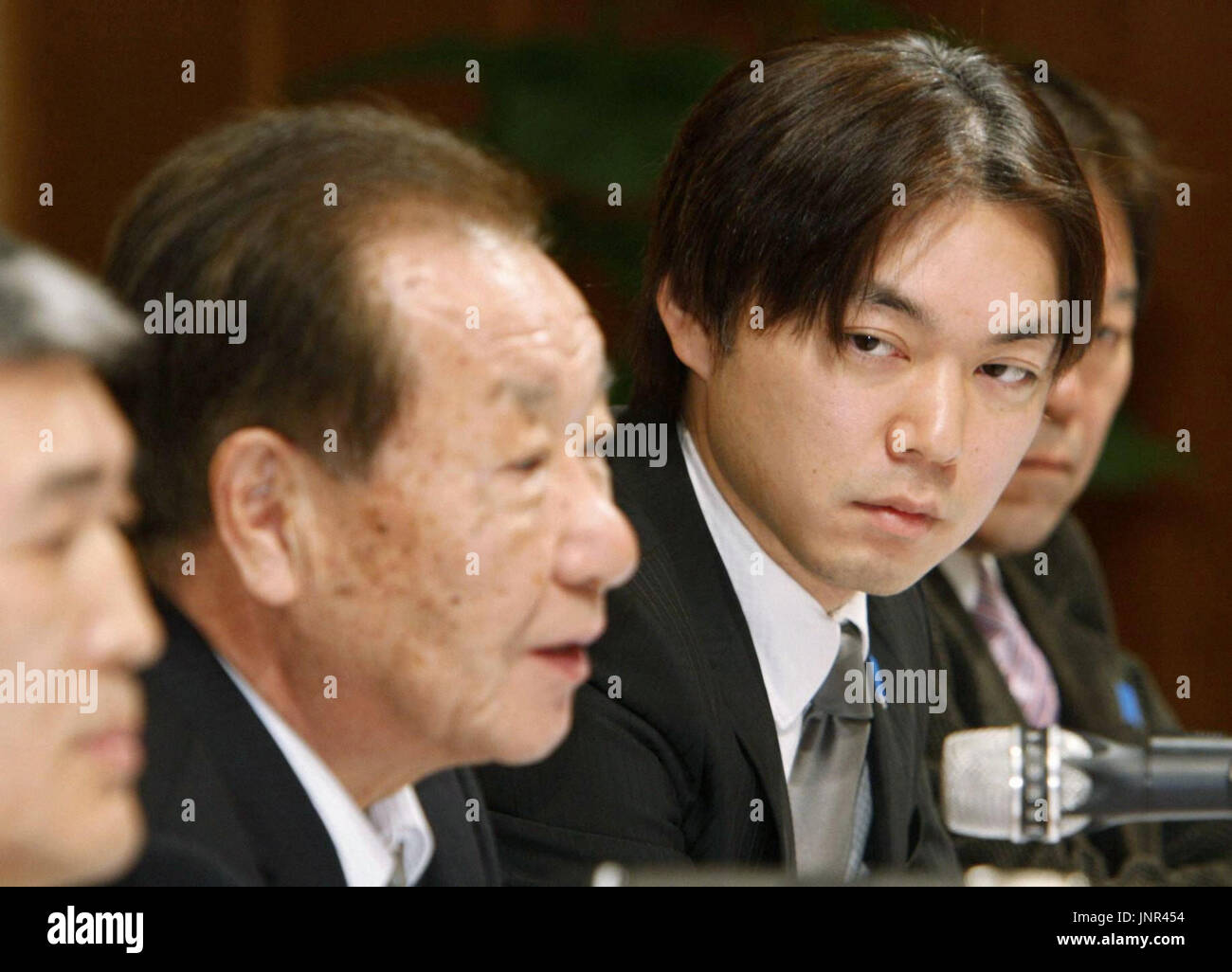 NARITA, Japan - Koichiro Iizuka (R), son of Japanese abductee Yaeko Taguchi, looks at Shigeo ...