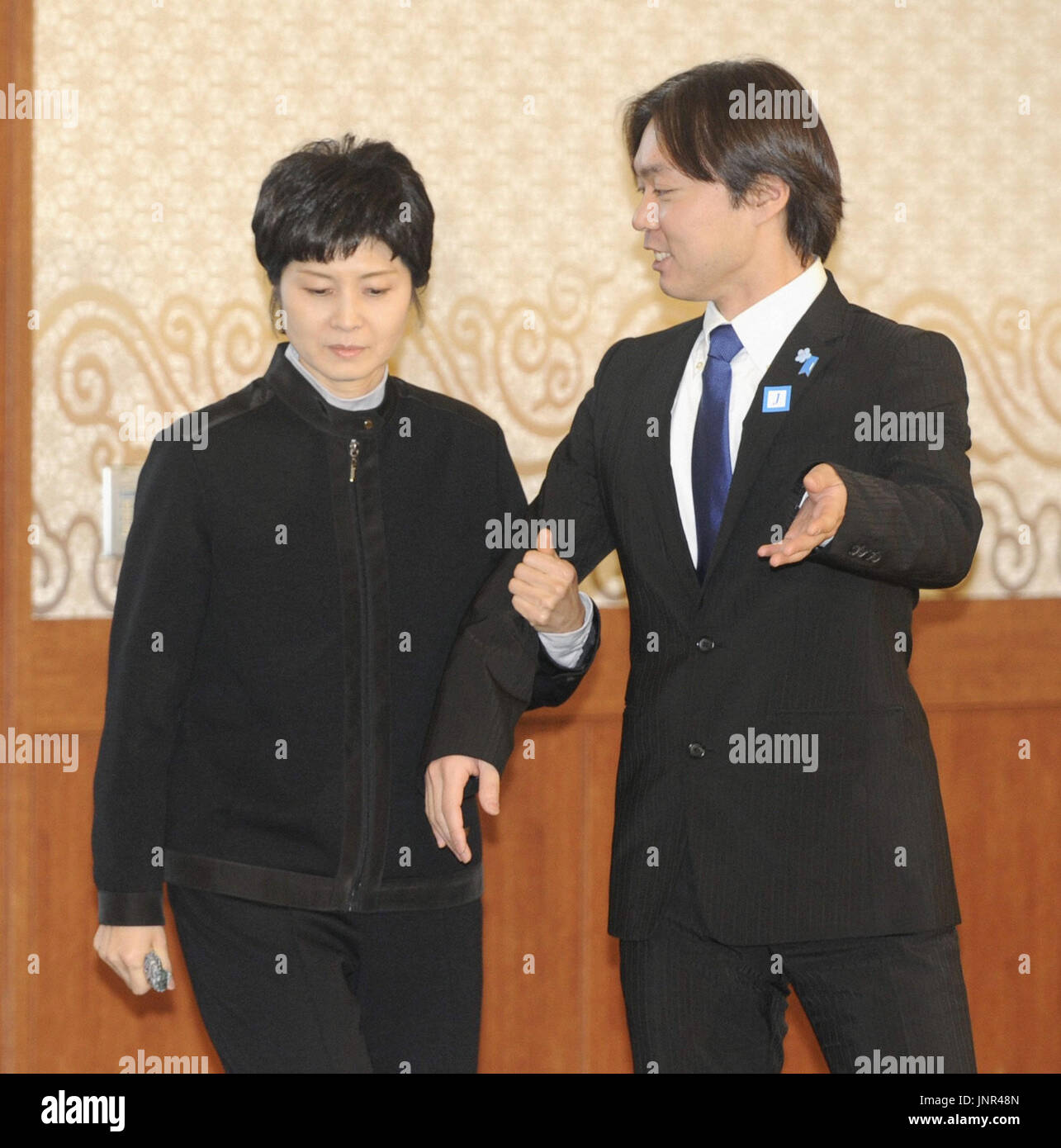 BUSAN, South Korea - Former North Korean agent Kim Hyon Hui (L) holds the arm of Koichiro Iizuka ...