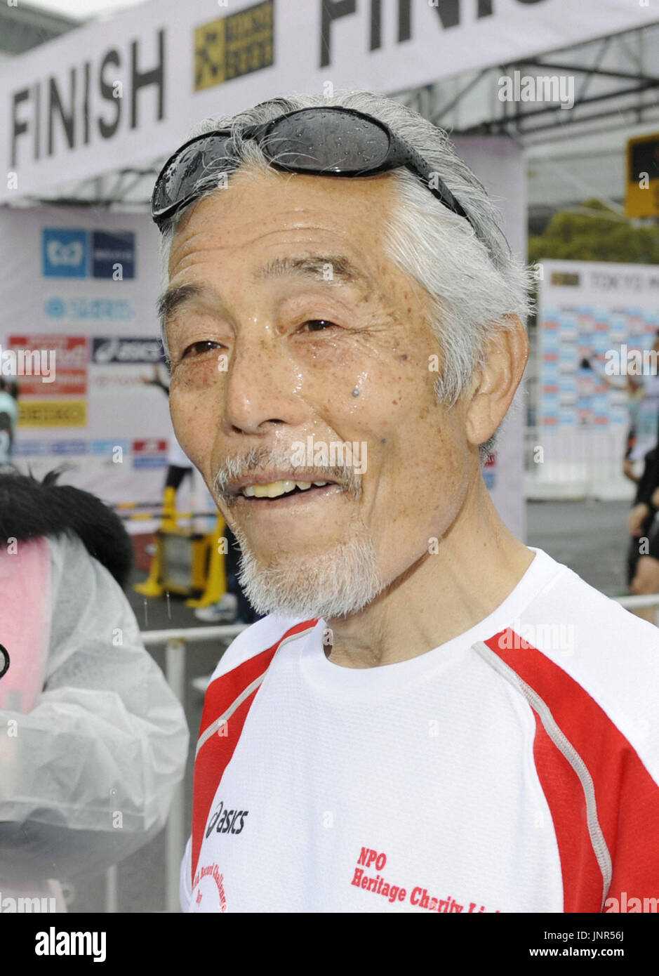 TOKYO, Japan - Japanese runner Akinori Kusuda smiles after completing ...