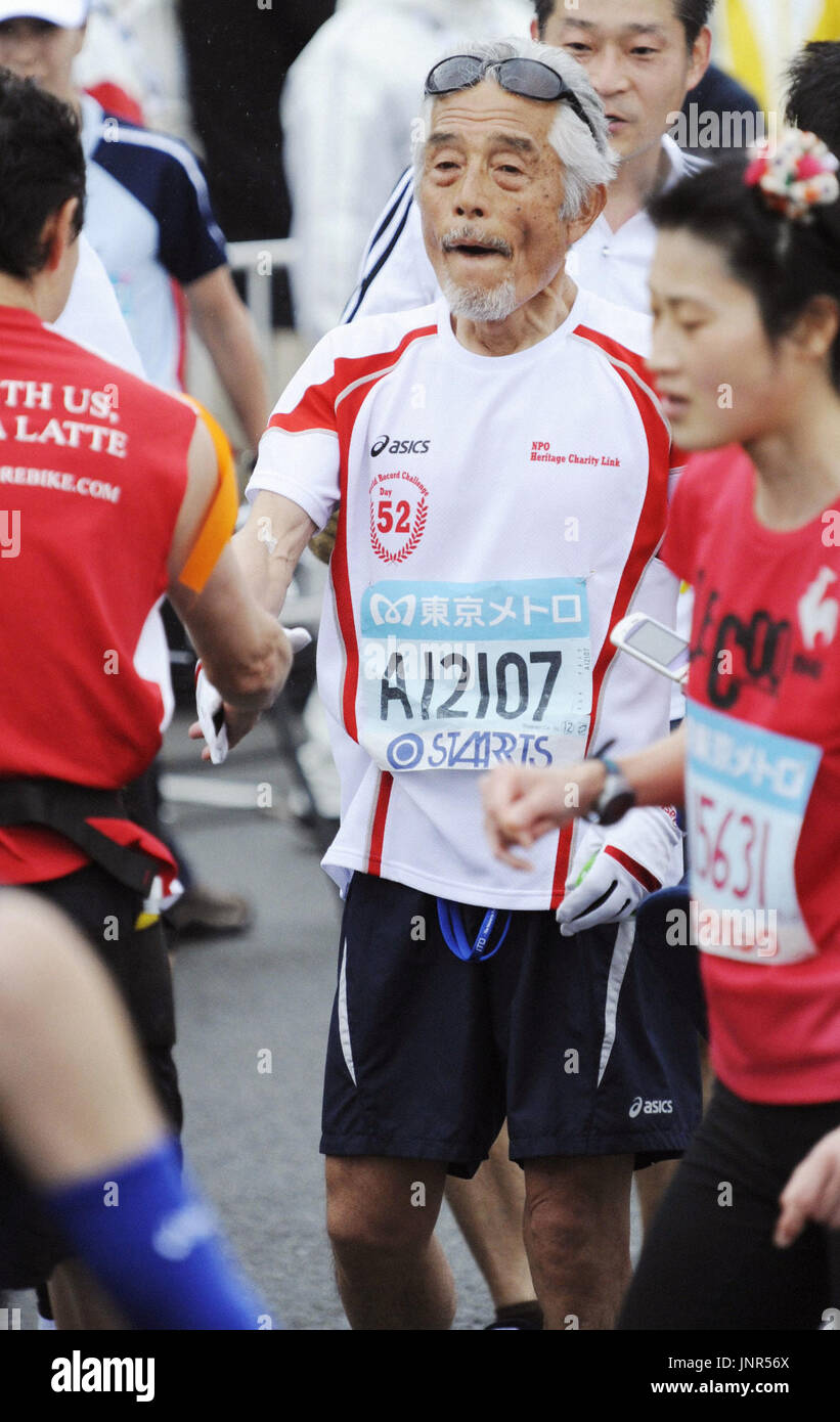 TOKYO, Japan - Japanese runner Akinori Kusuda shakes hands with another ...