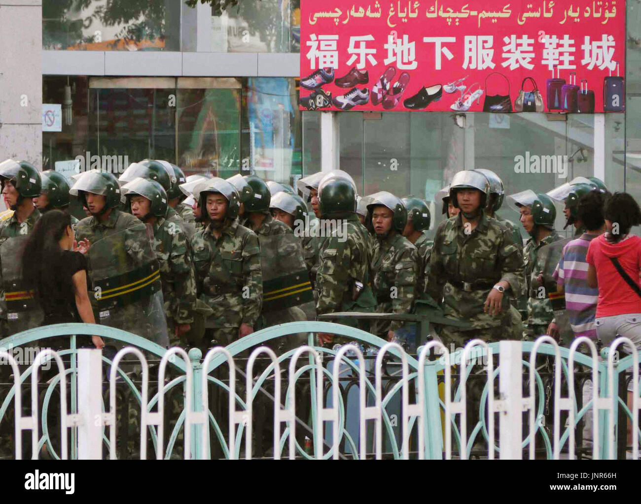 URUMQI, China - Chinese paramilitary police patrols near a market in ...
