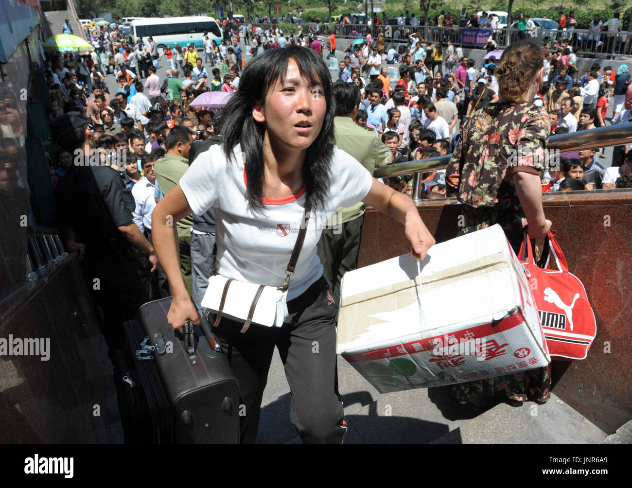 URUMQI, China - A Uyghur woman heads for a bus on July 9 to escape from ...