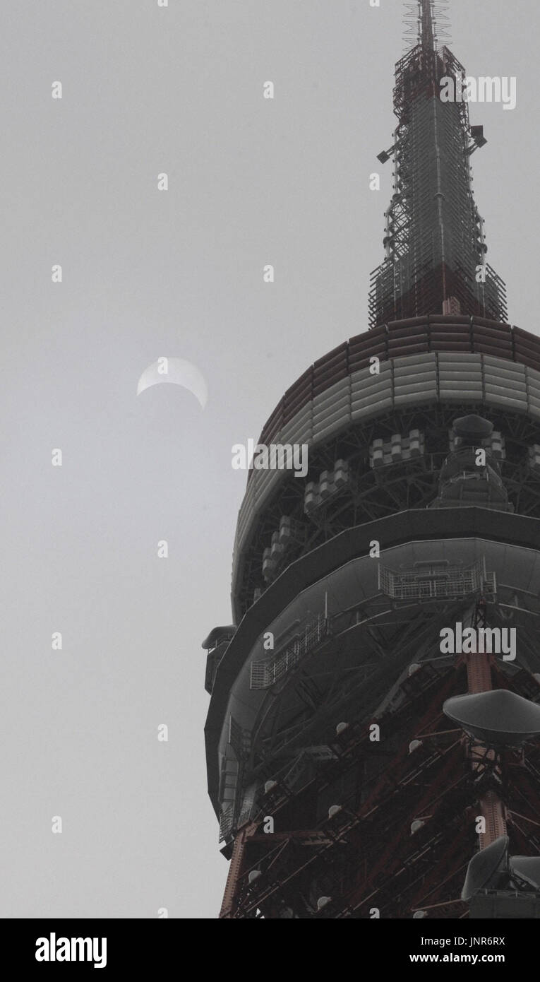 TOKYO, Japan - A solar eclipse is observed in the pallid sky near Tokyo ...