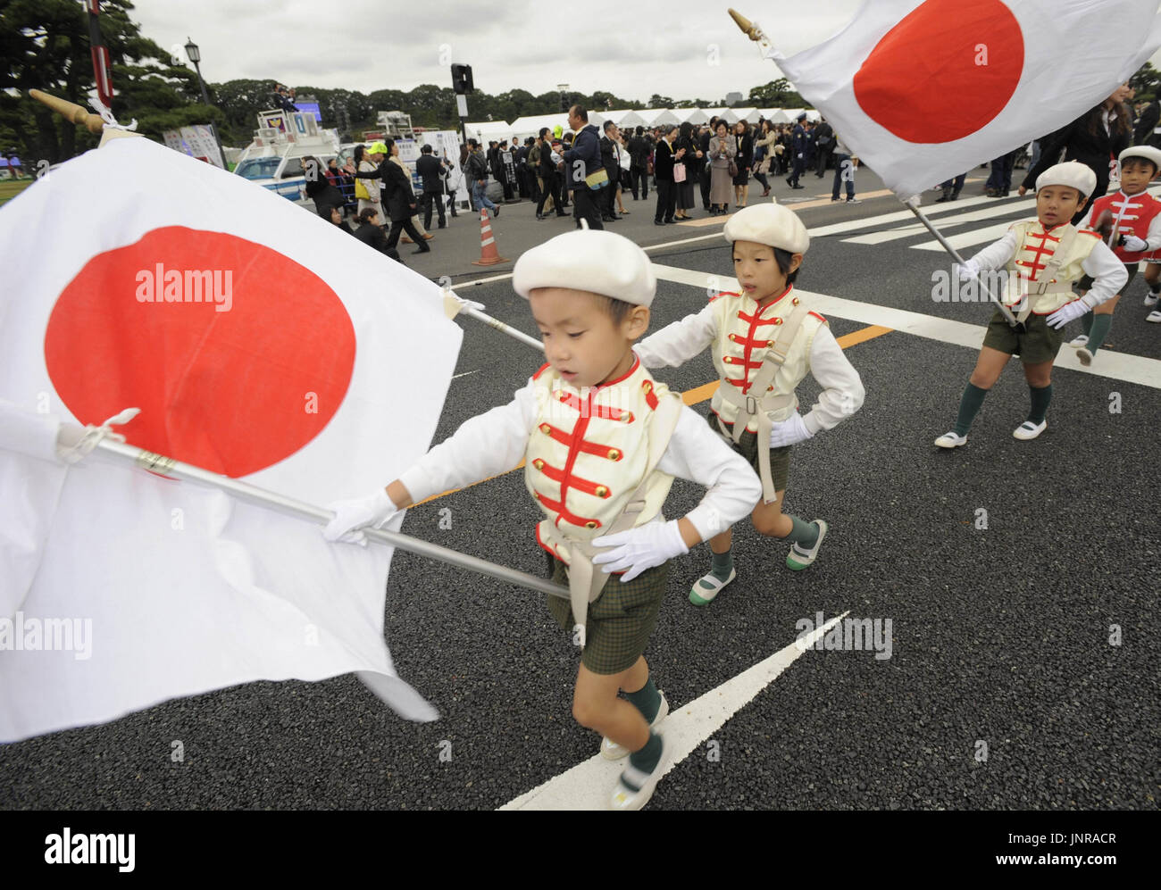 TOKYO, Japan - Children carry Japanese national flags during a parade ...