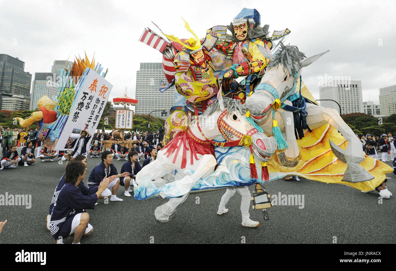 TOKYO, Japan - A man carries a decoration during a parade to celebrate ...
