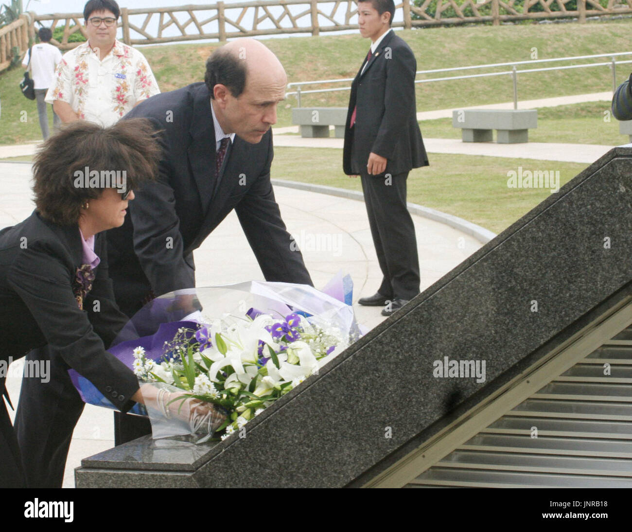 NAHA, Japan - U.S. Ambassador to Japan John Roos (C) lays flowers at ...