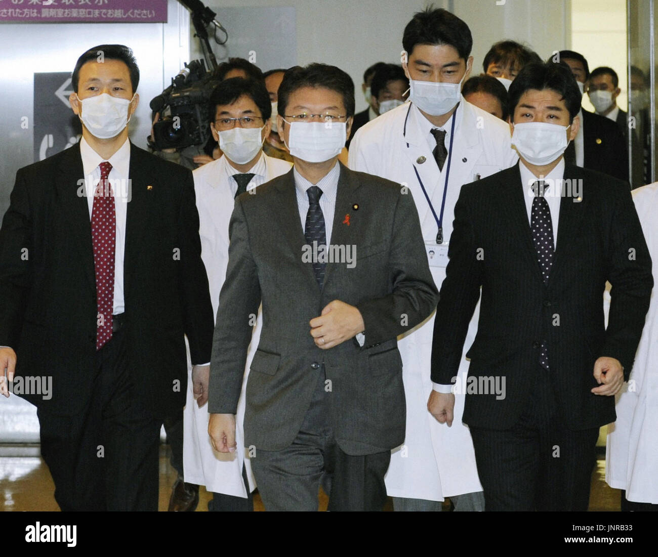TOKYO, Japan - Health minister Akira Nagatsuma (C), wearing an anti-flu ...