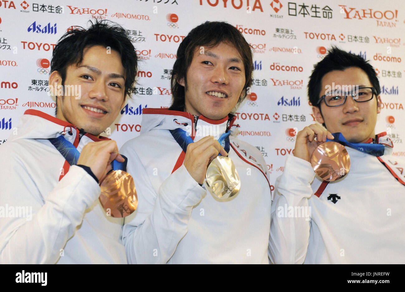 VANCOUVER, Canada - Japanese Olympic medalists hold up their medals ...