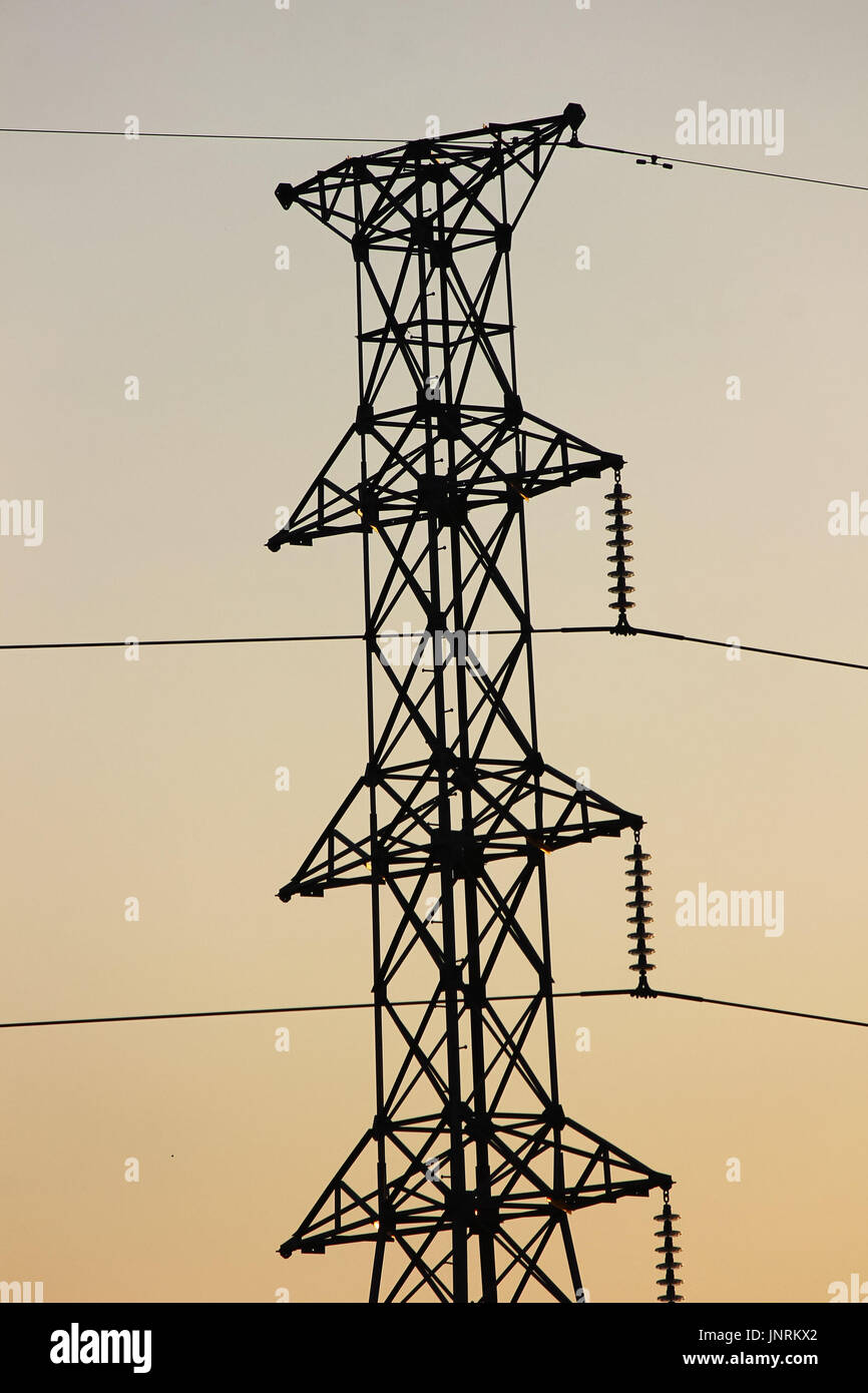 Power Transmission Line with Yellow sky sunset background Stock Photo ...