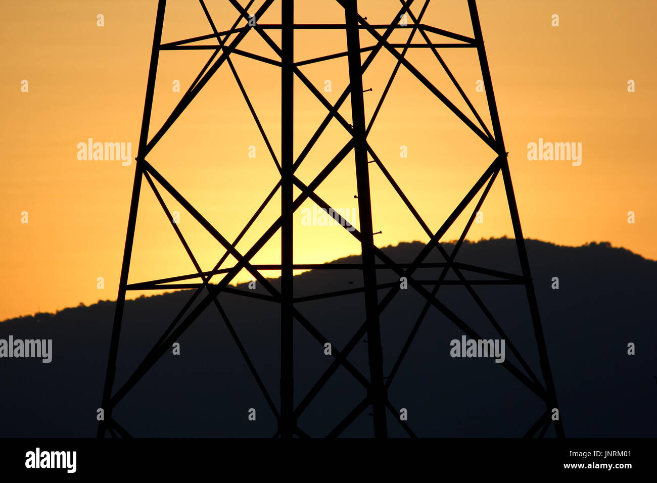 Power Transmission Line with Yellow sky sunset background Stock Photo ...