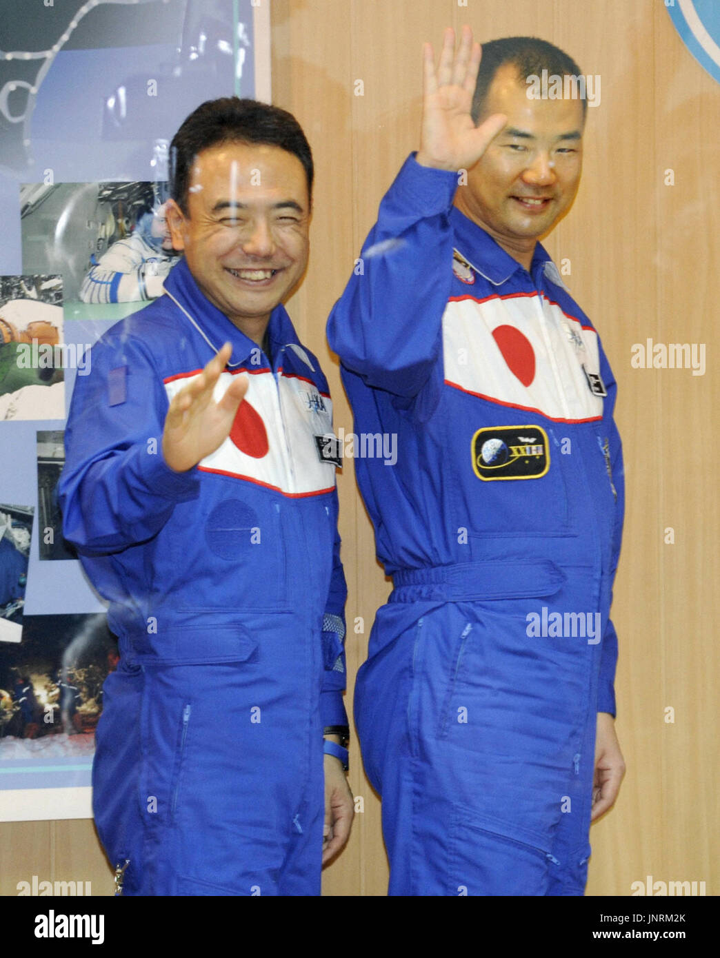 BIKONUR, Kazakhstan - Japanese astronauts Soichi Noguchi (R) and Satoshi Furukawa wave after a ...