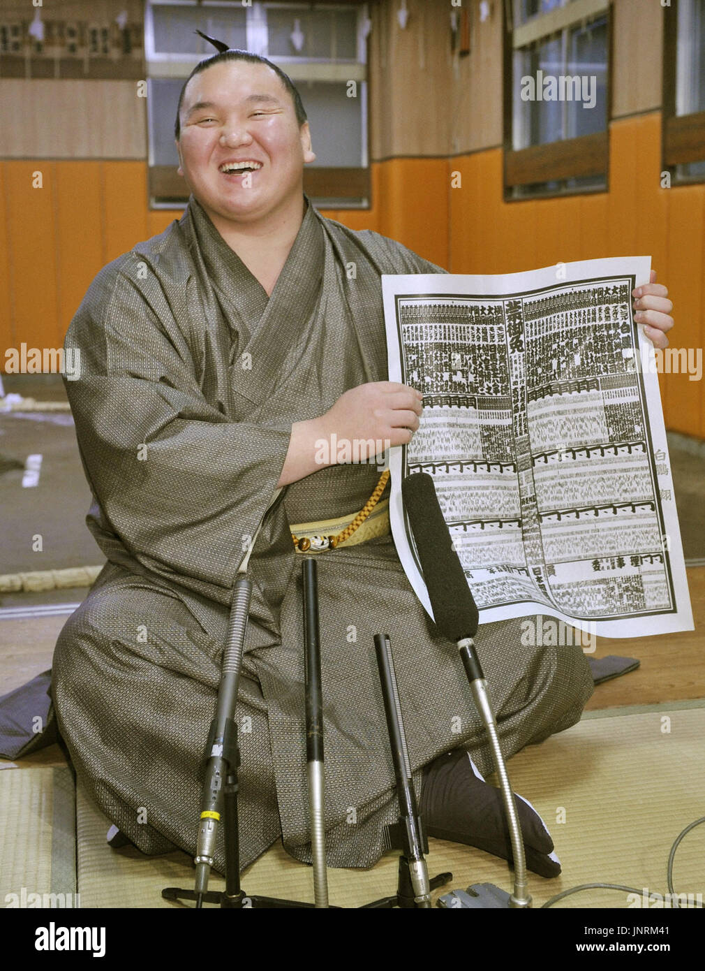 TOKYO, Japan - Sumo grand champion Hakuho smiles holding a ranking ...