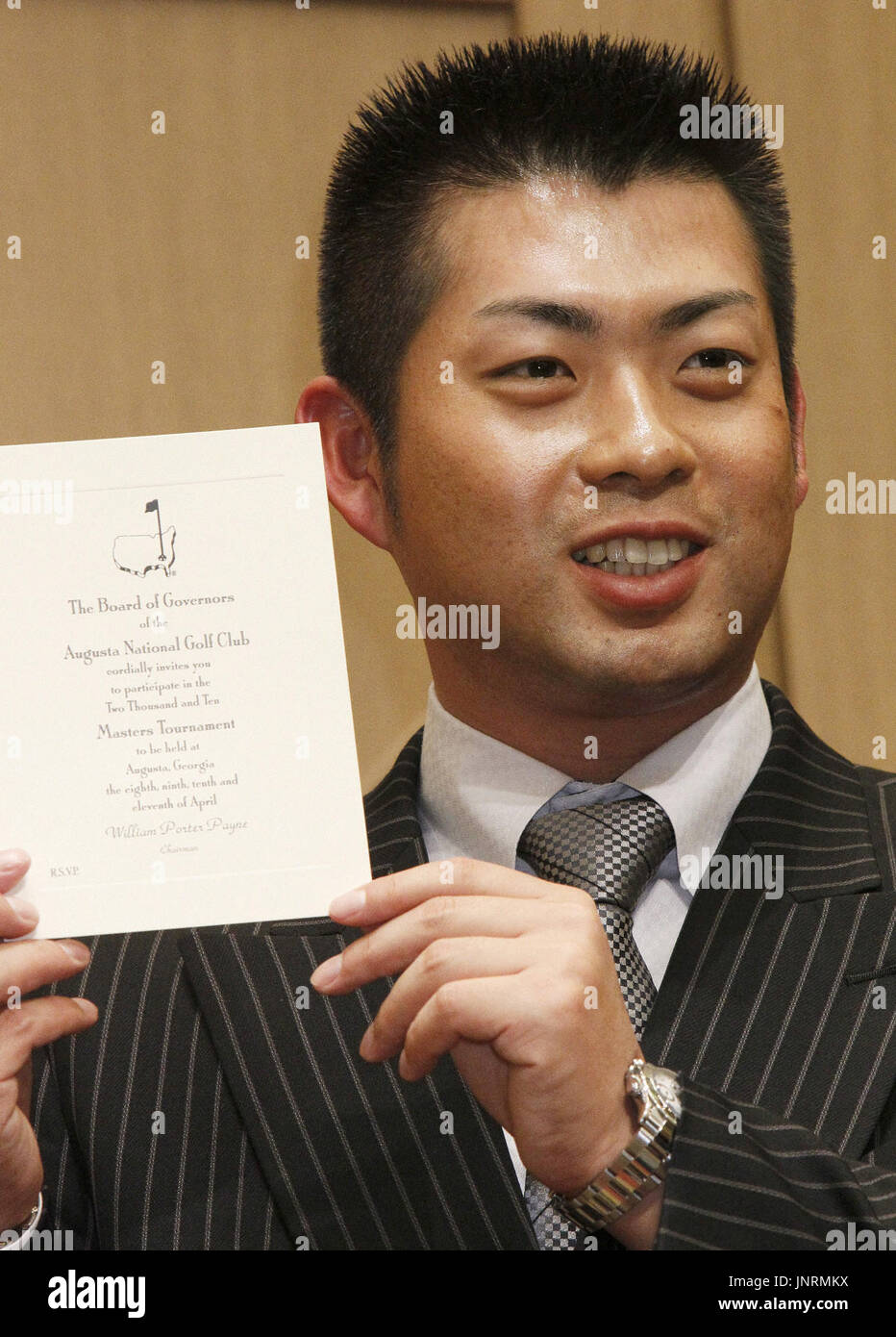 TOKYO, Japan - Japanese golfer Yuta Ikeda holds up his invitation from ...