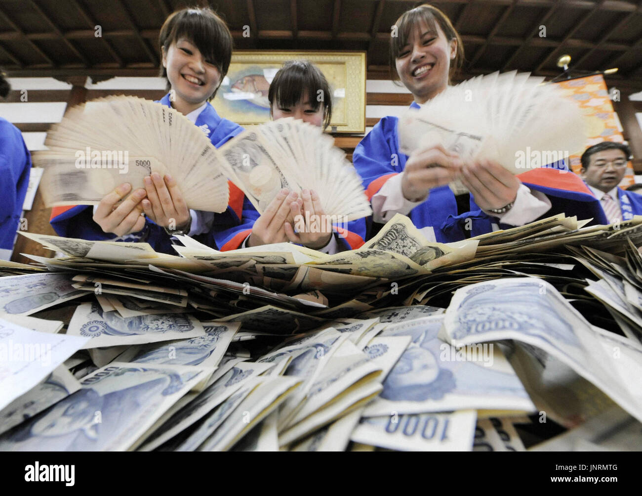 OSAKA, Japan - Female bank staffers wearing traditional Japanese happi ...