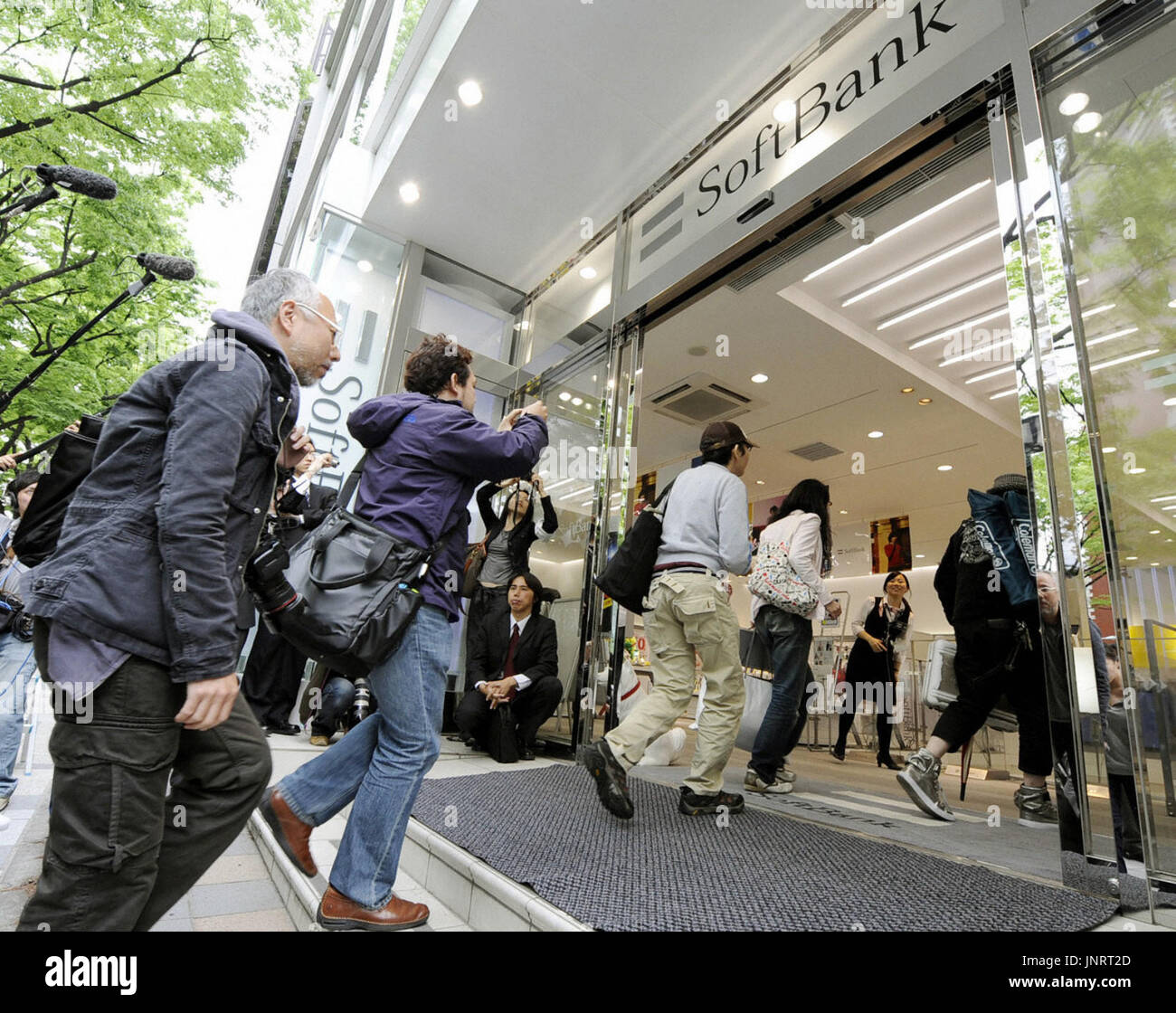TOKYO, Japan - People enter an Omotesando outlet of Softbank Mobile ...