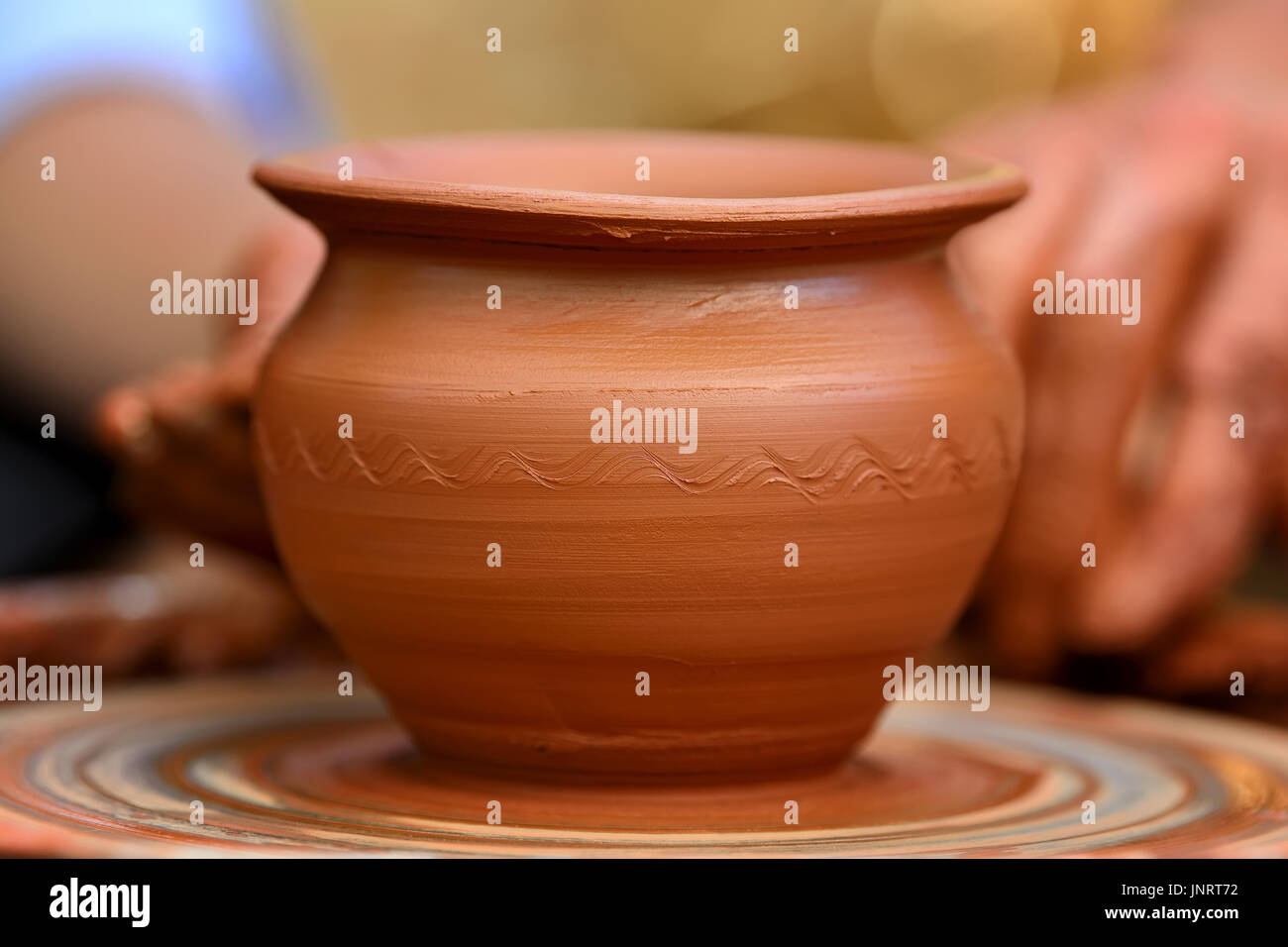 Hands of a potter. Potter making ceramic pot on the pottery wheel Stock ...