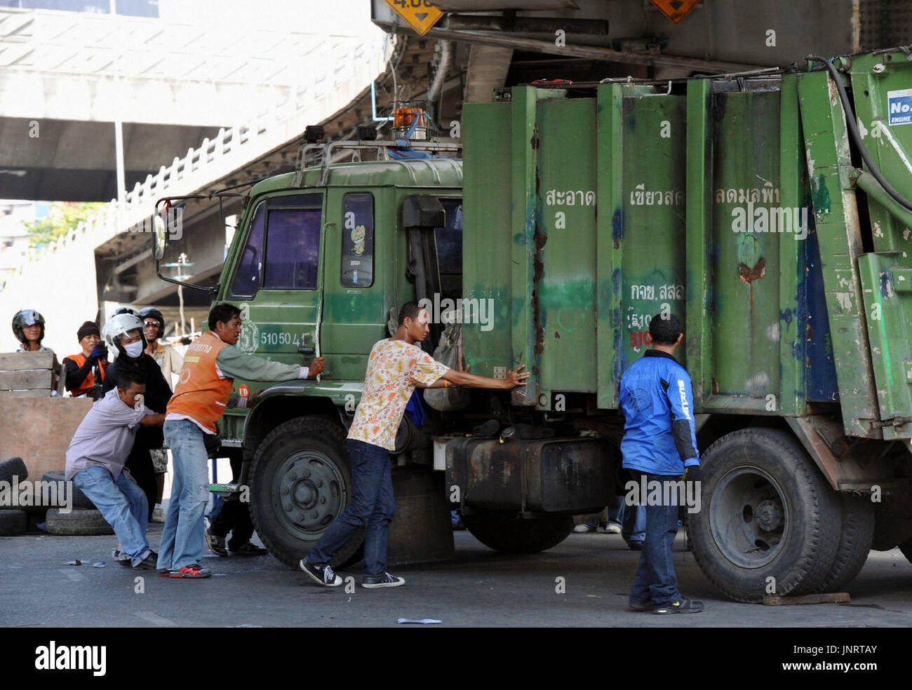 BANGKOK, Thailand - Antigovernment protesters move a garbage truck to ...