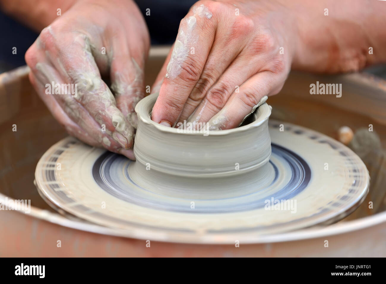 Hands of a potter. Potter making ceramic pot on the pottery wheel Stock ...