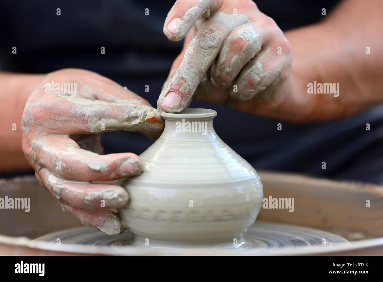 Hands of a potter. Potter making ceramic pot on the pottery wheel Stock ...
