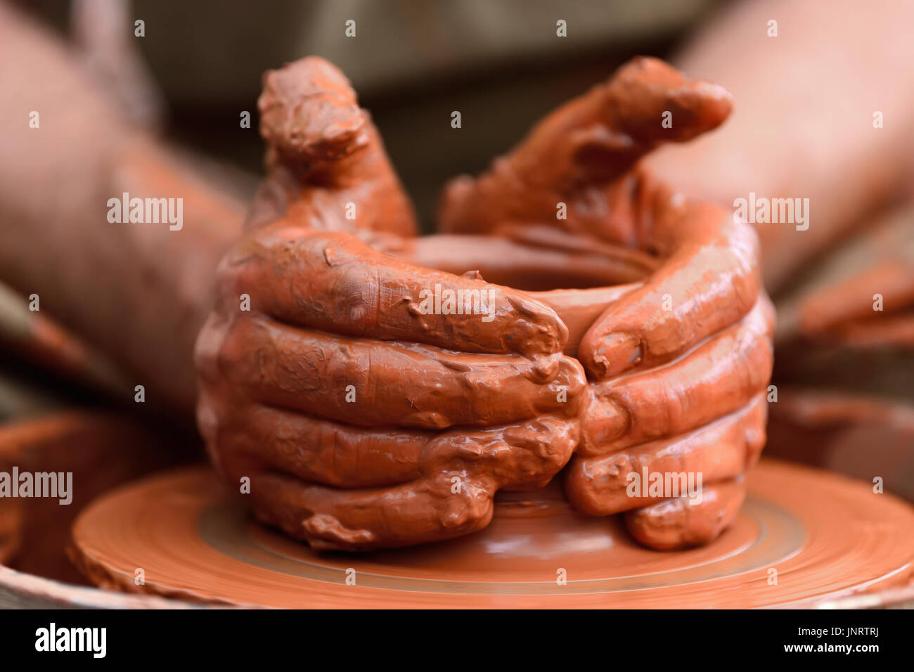 Hands of a potter. Potter making ceramic pot on the pottery wheel Stock ...