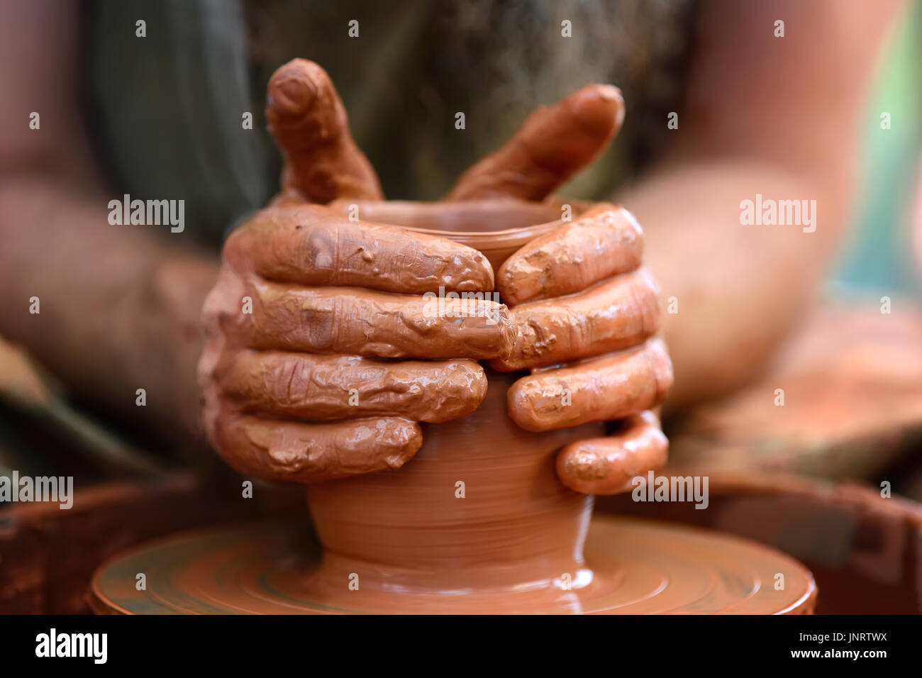 Hands of a potter. Potter making ceramic pot on the pottery wheel Stock ...