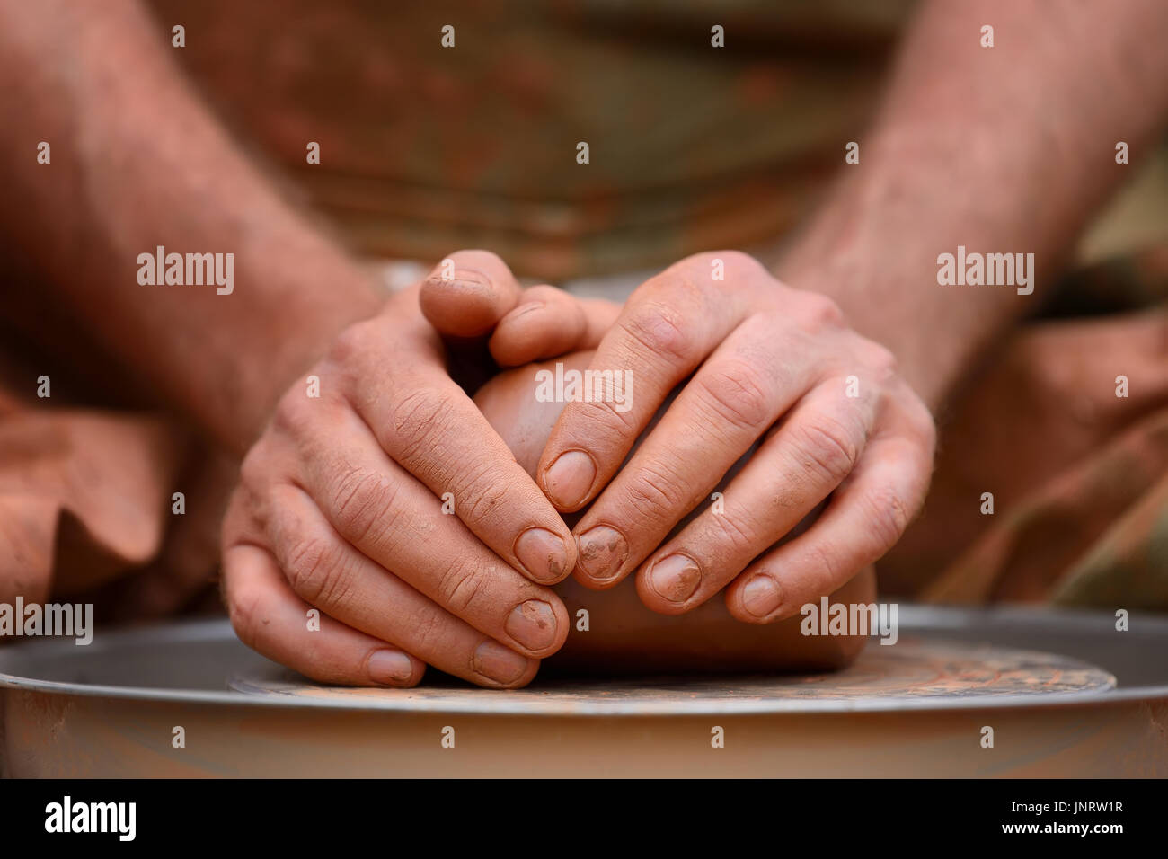 Hands of a potter. Potter making ceramic pot on the pottery wheel Stock ...