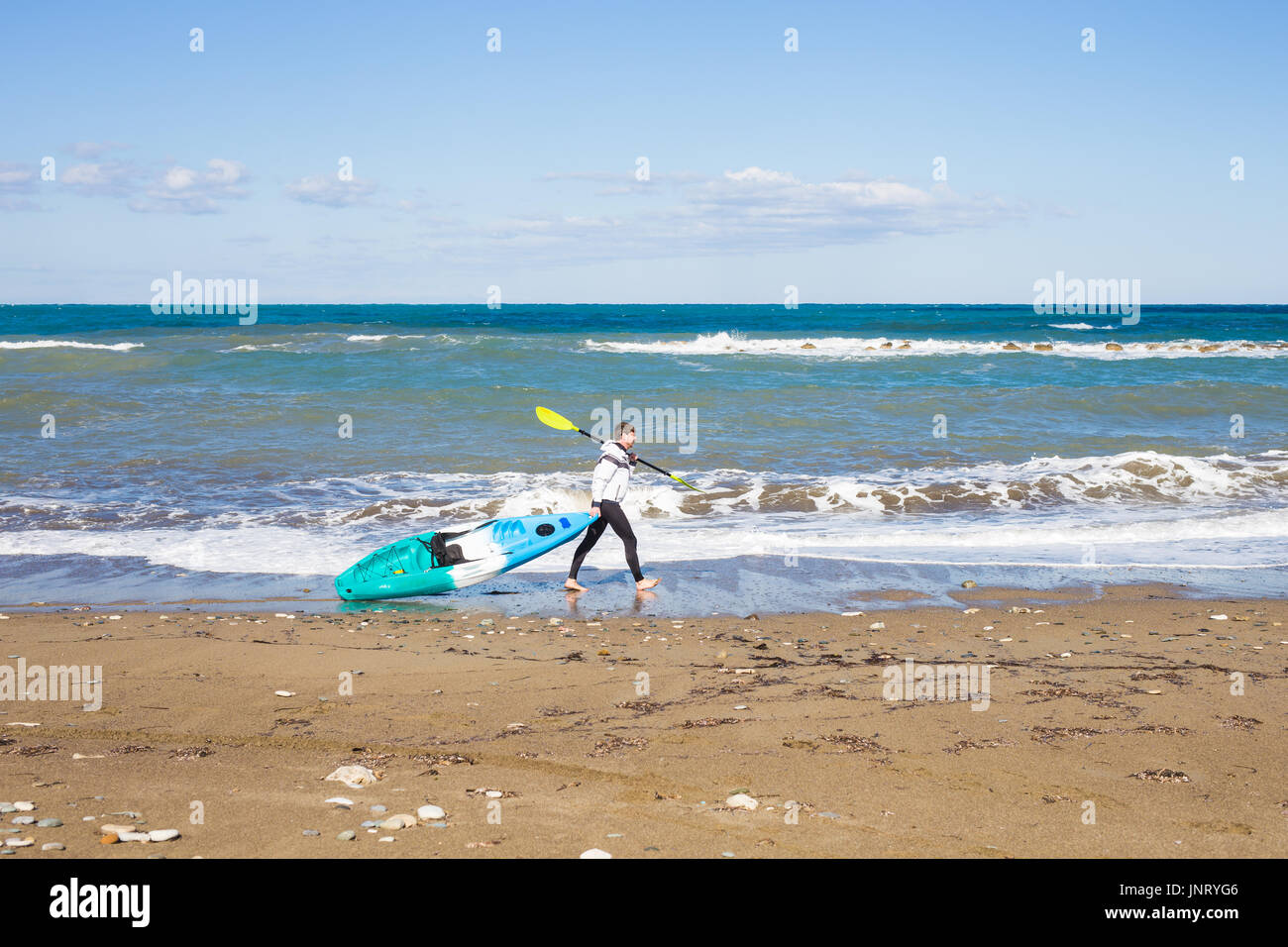 Man walking on the beach with kayak. Traveling by sea. Leisure ...