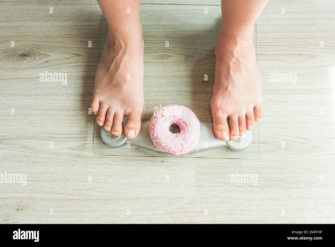 Diet Concept. Close-up of Woman's feet On Weighing Scale With Donut ...