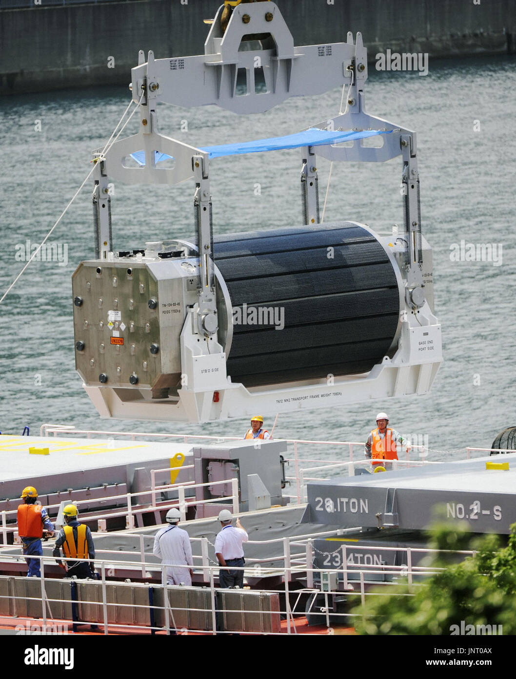TAKAHAMA, Japan - A crane lifts a container of plutonium-uranium mixed ...
