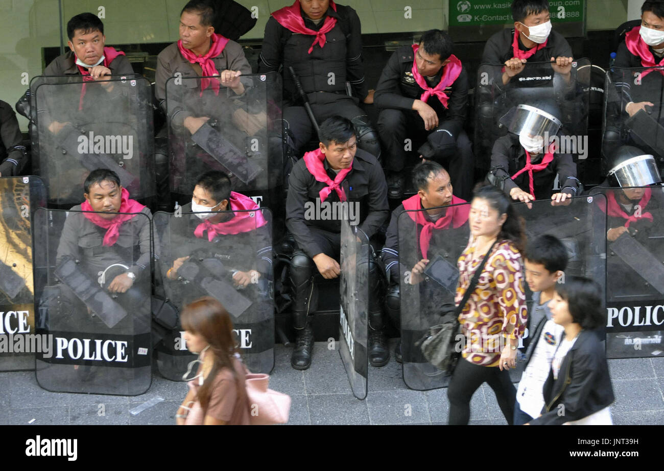 BANGKOK, Thailand - Thai police officers take positions along a walkway ...