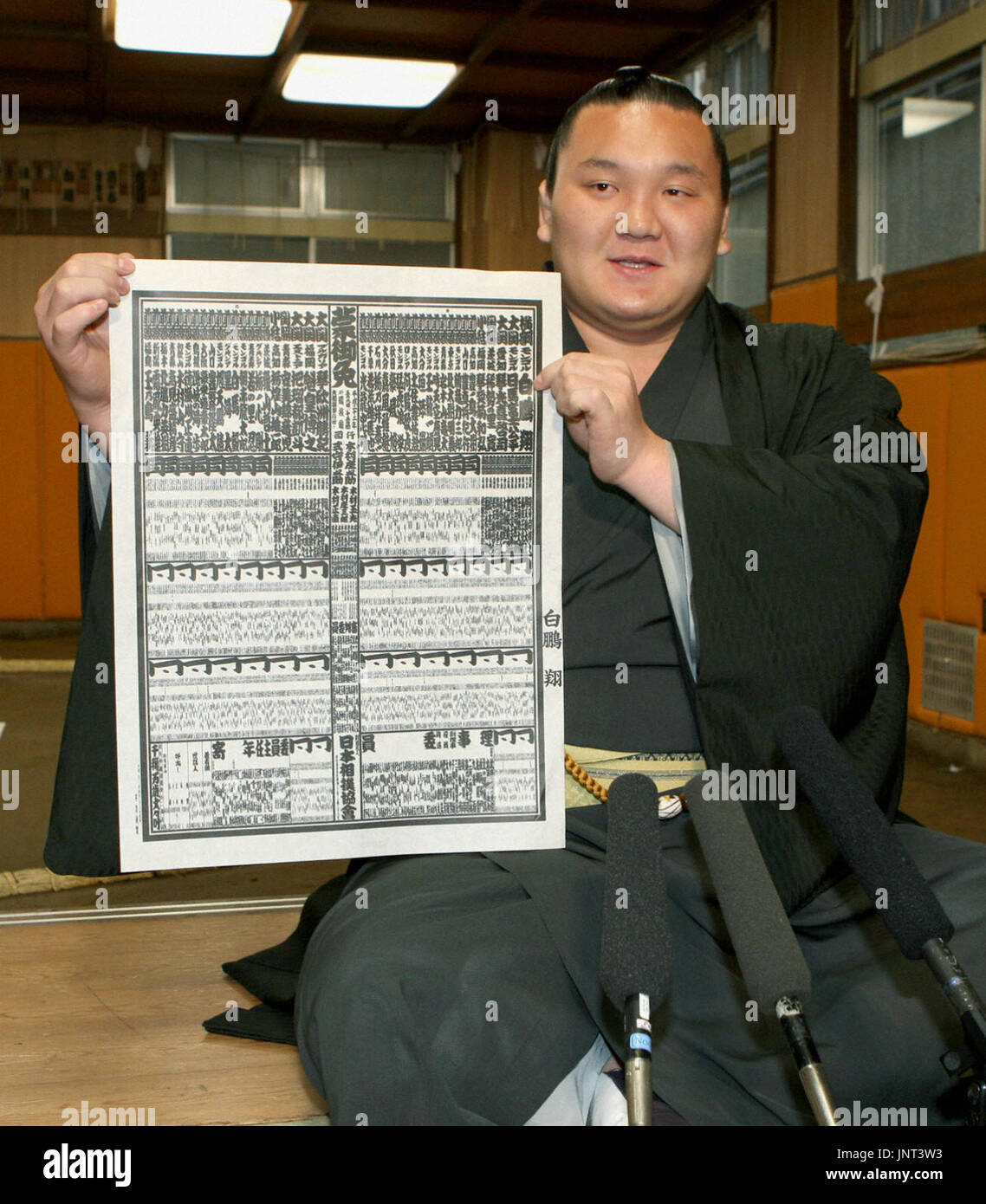 TOKYO, Japan - Mongolian yokozuna (grand champion) Hakuho holds up a ...