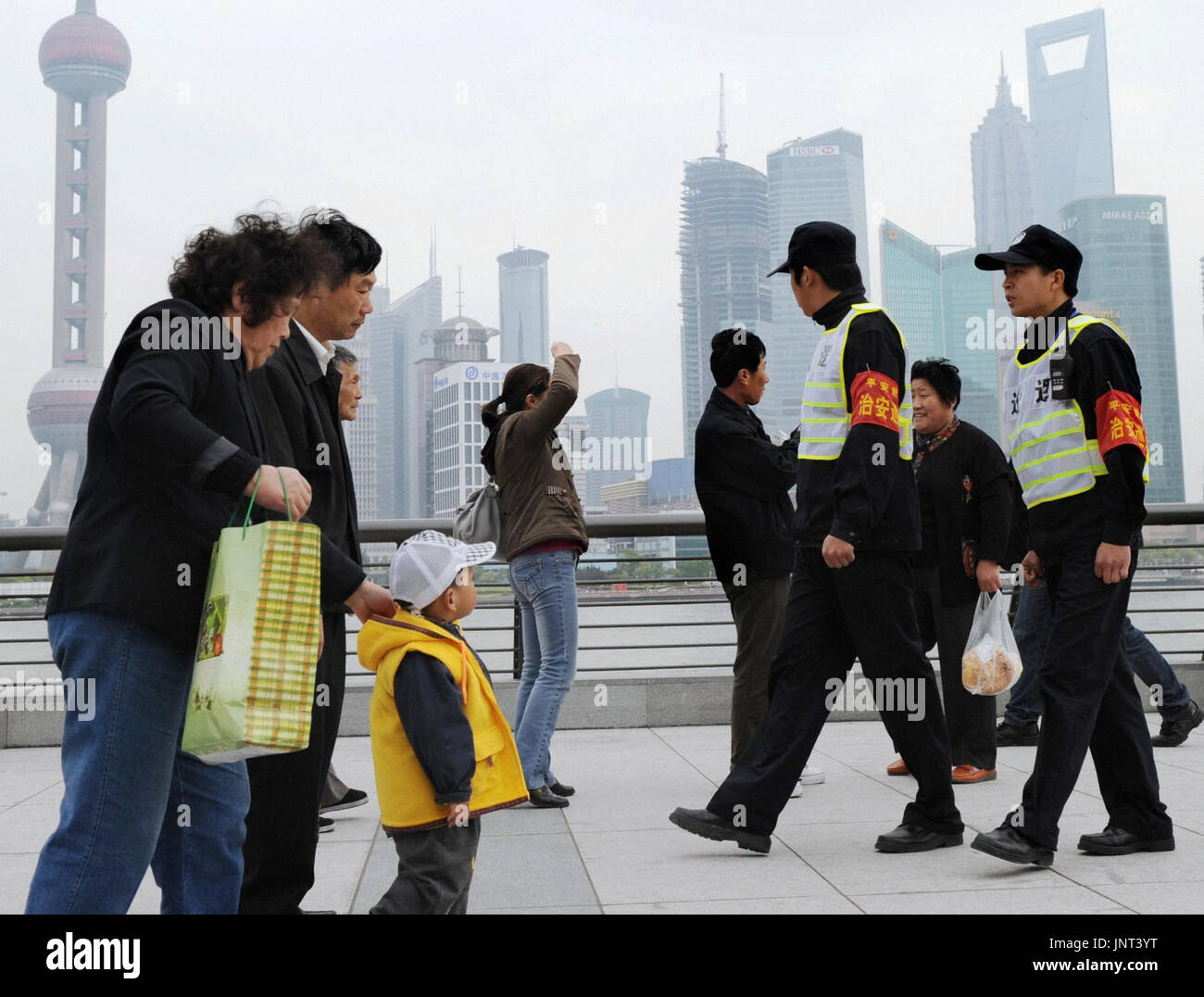 SHANGHAI, China - Security volunteer workers (R) patrol the popular ...