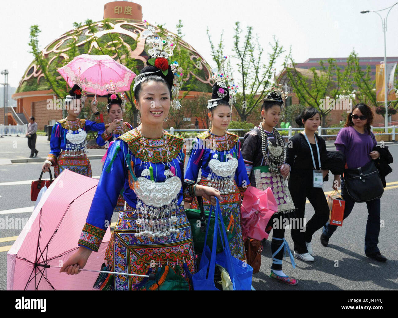 SHANGHAI, China - Women wearing ethnic costumes walk to the World Expo ...