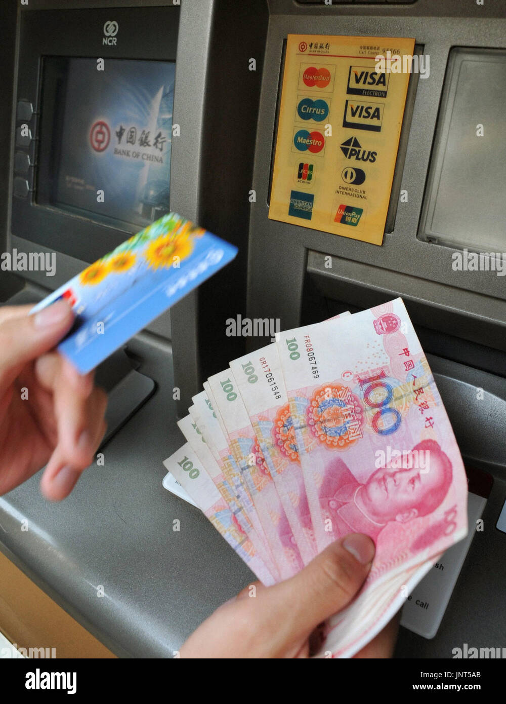 BEIJING, China - Photo shows yuan bills and an automated teller machine ...