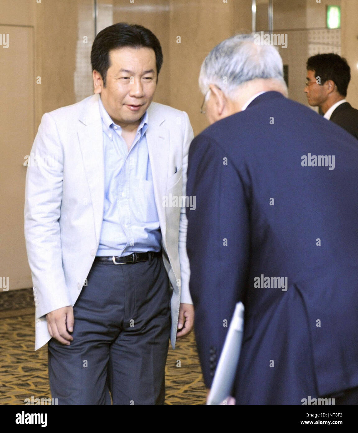 TOKYO, Japan - Democratic Party of Japan Secretary General Yukio Edano (L) is greeted by Japan ...