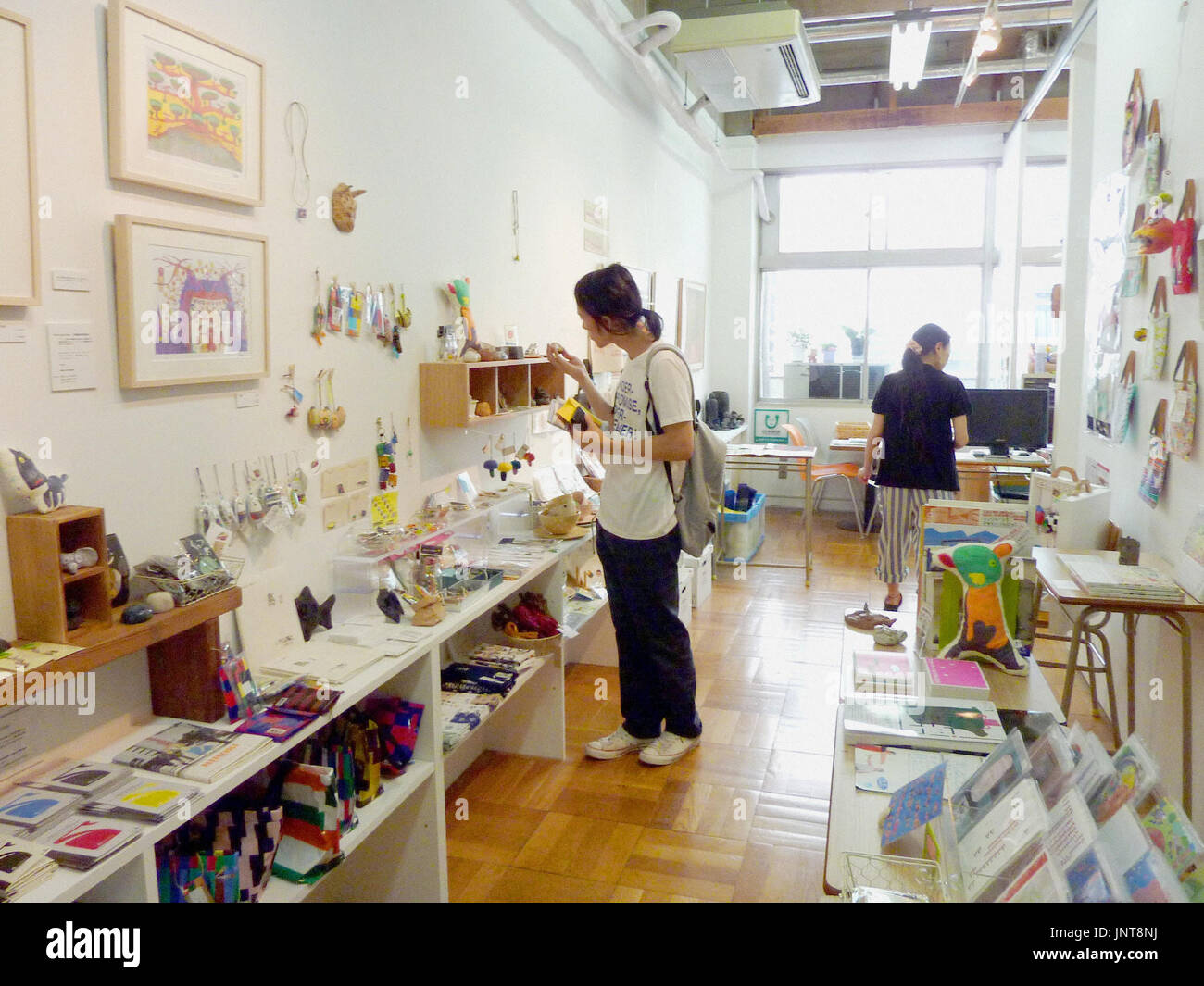 TOKYO, Japan - A visitor looks at artwork at a shop adjacent to the A/A ...