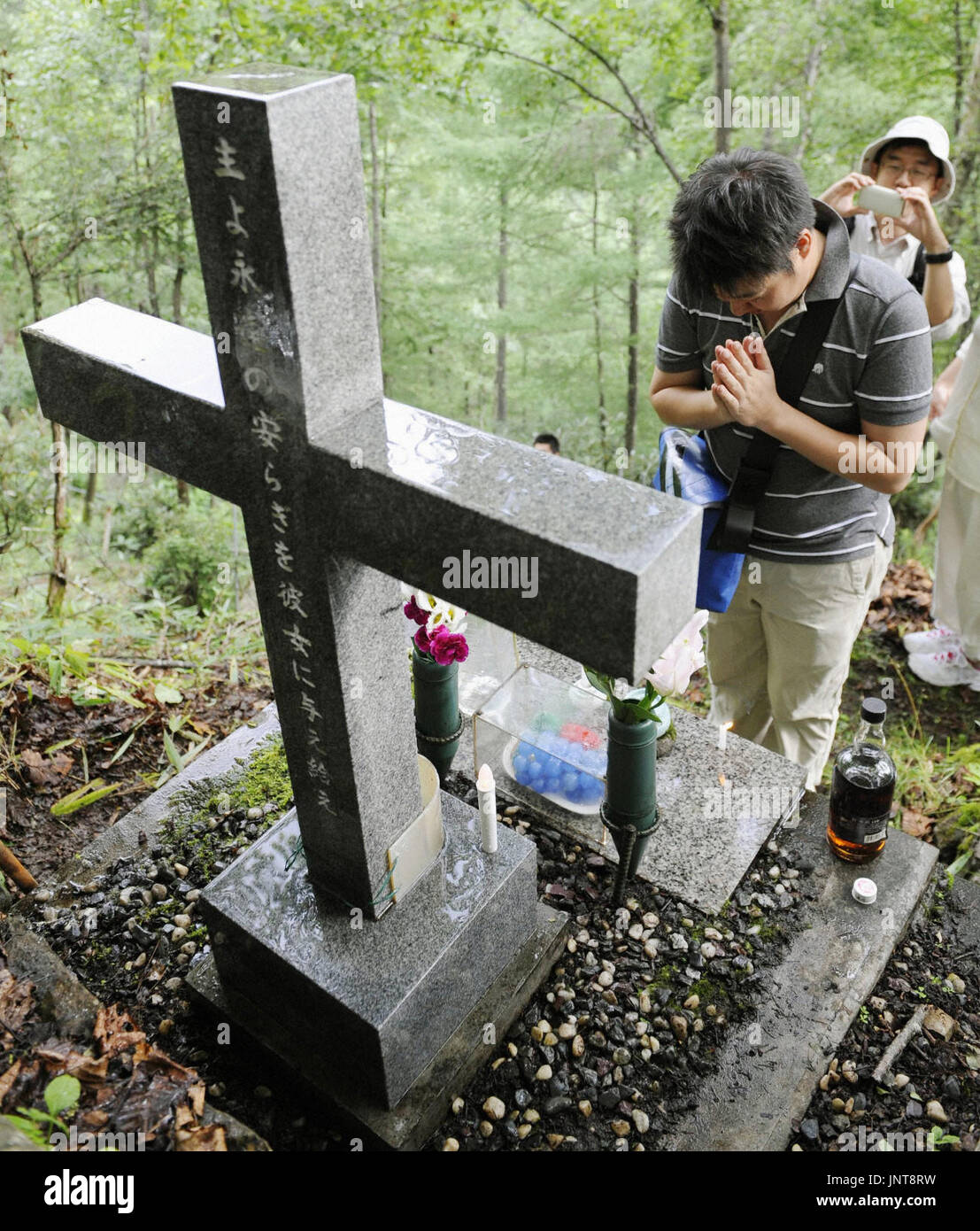 UENO, Japan - A man prays in front of a monument to the victims of the ...