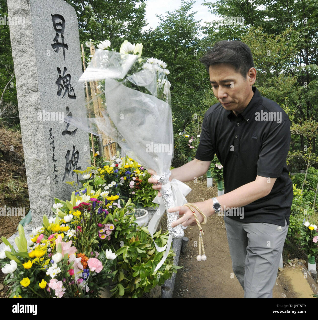 UENO, Japan - Transport minister Seiji Maehara offers flowers at the ...