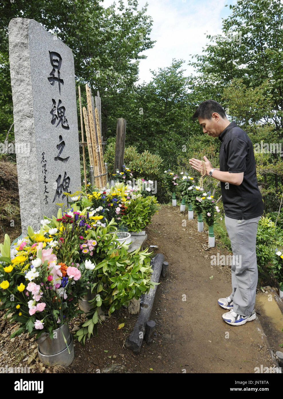UENO, Japan - Transport minister Seiji Maehara prays in front of the ...
